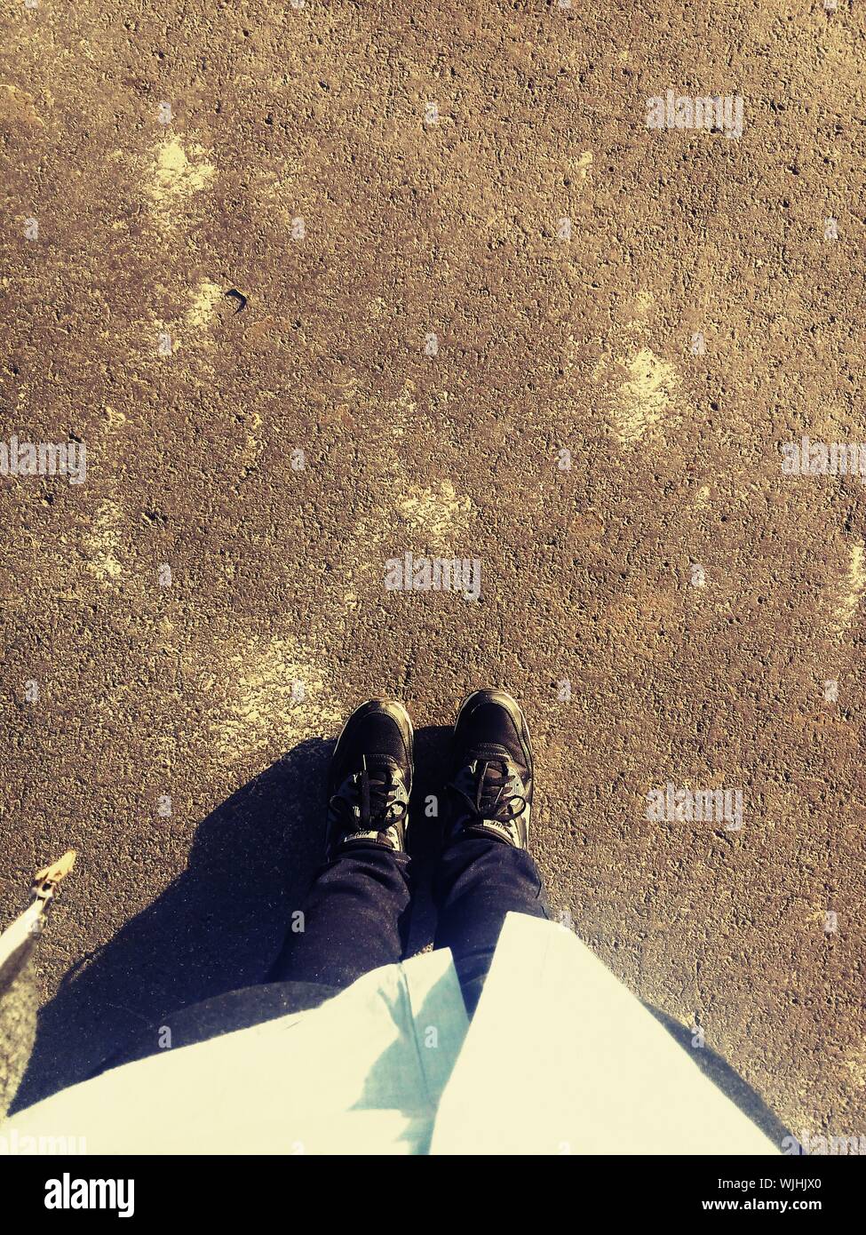 Low Section Of Person Standing On Street Stock Photo - Alamy