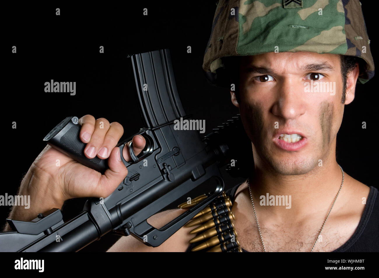 Aggressive soldier man holding gun Stock Photo - Alamy