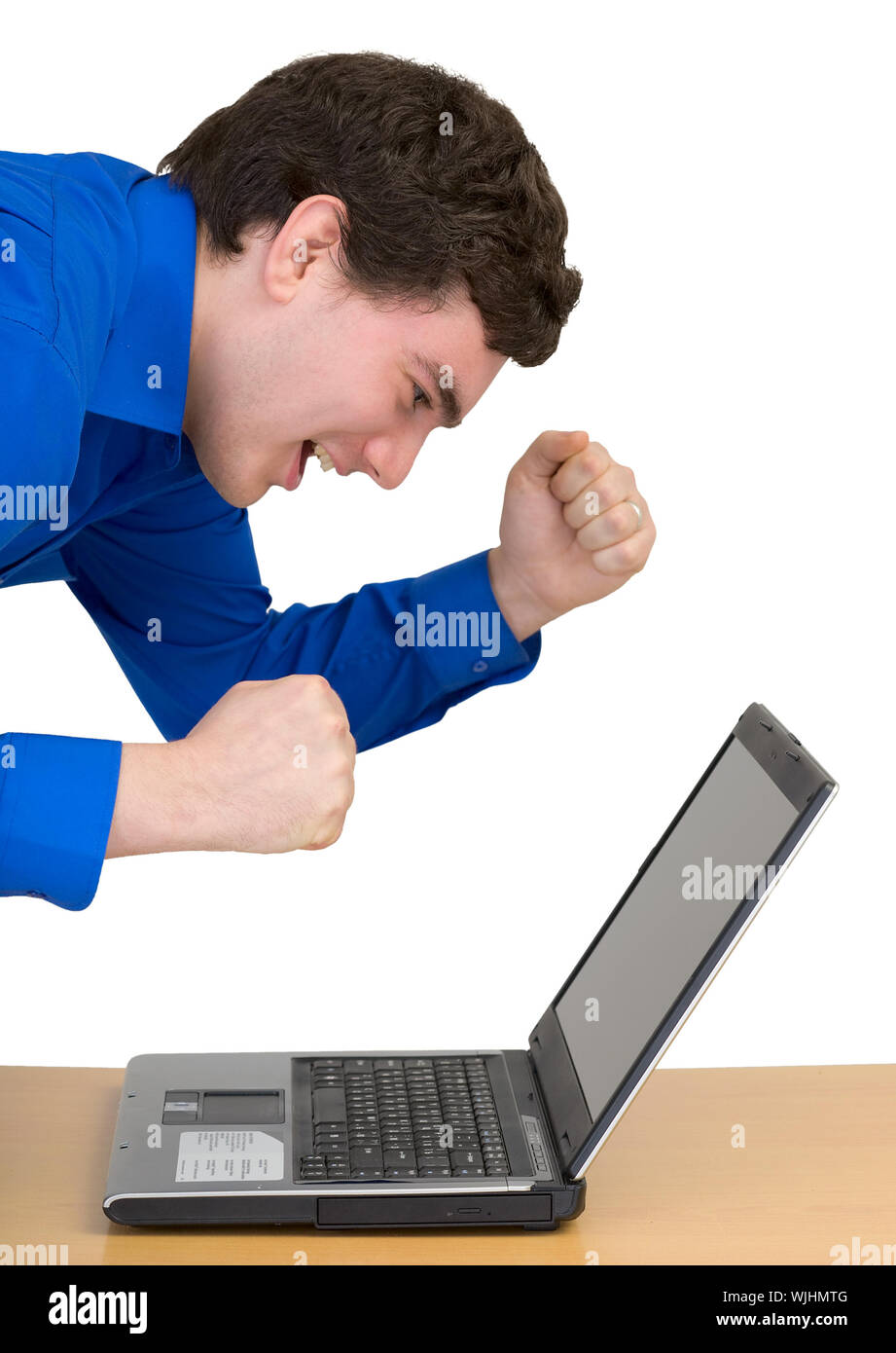 Emotional young man with the laptop on white background Stock Photo - Alamy