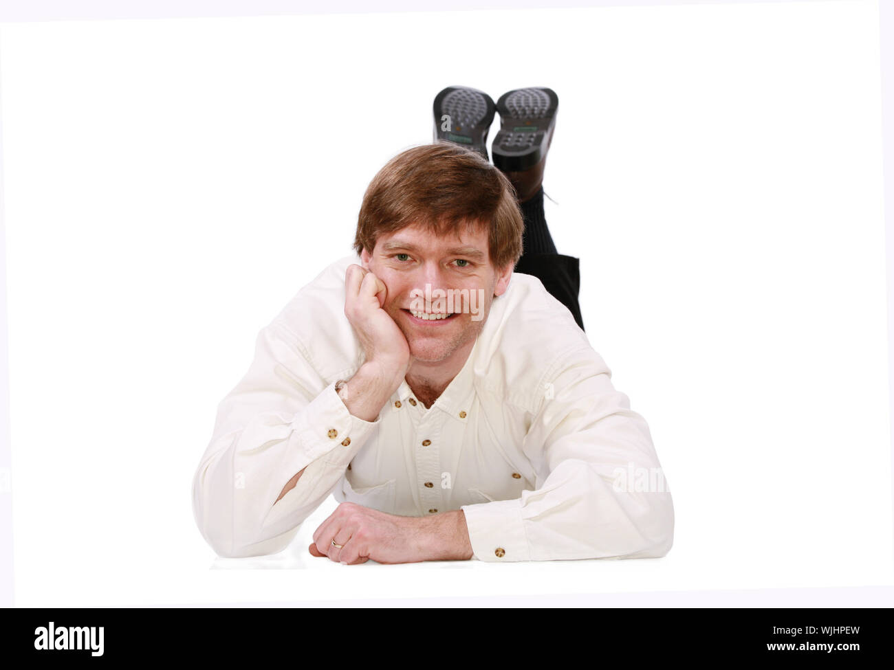 Handsome business man lying on floor relaxing, chin on hand Stock Photo ...