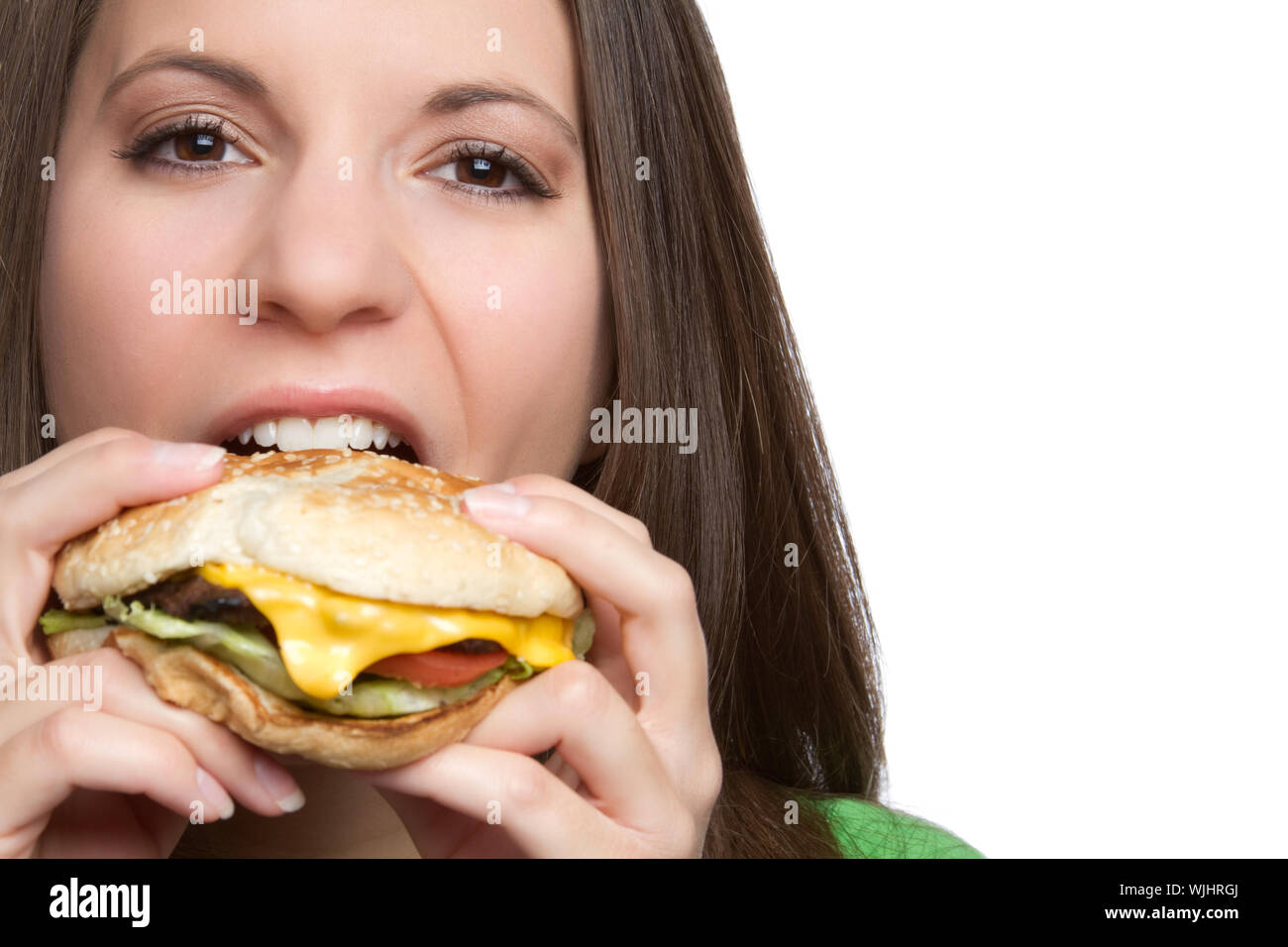 Beautiful girl eating hamburger food Stock Photo - Alamy