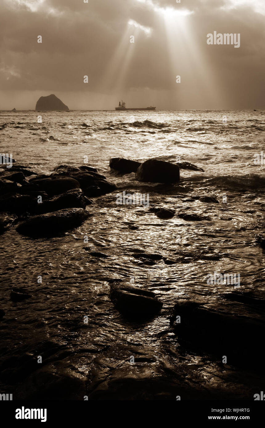 Here is a boat on the sea with strong light effect Stock Photo - Alamy
