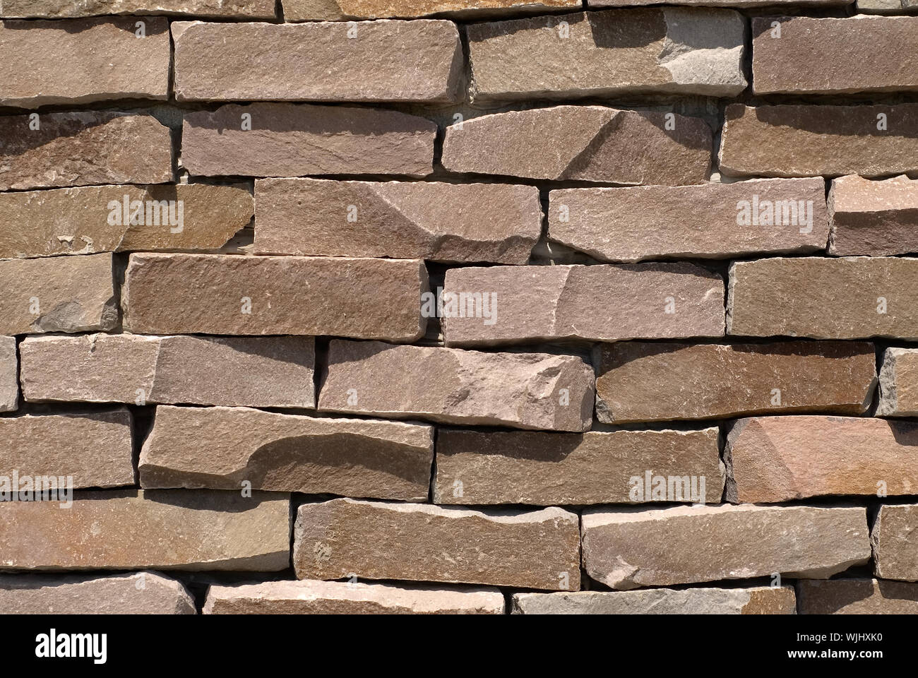 It is a stone wall with brown color Stock Photo - Alamy