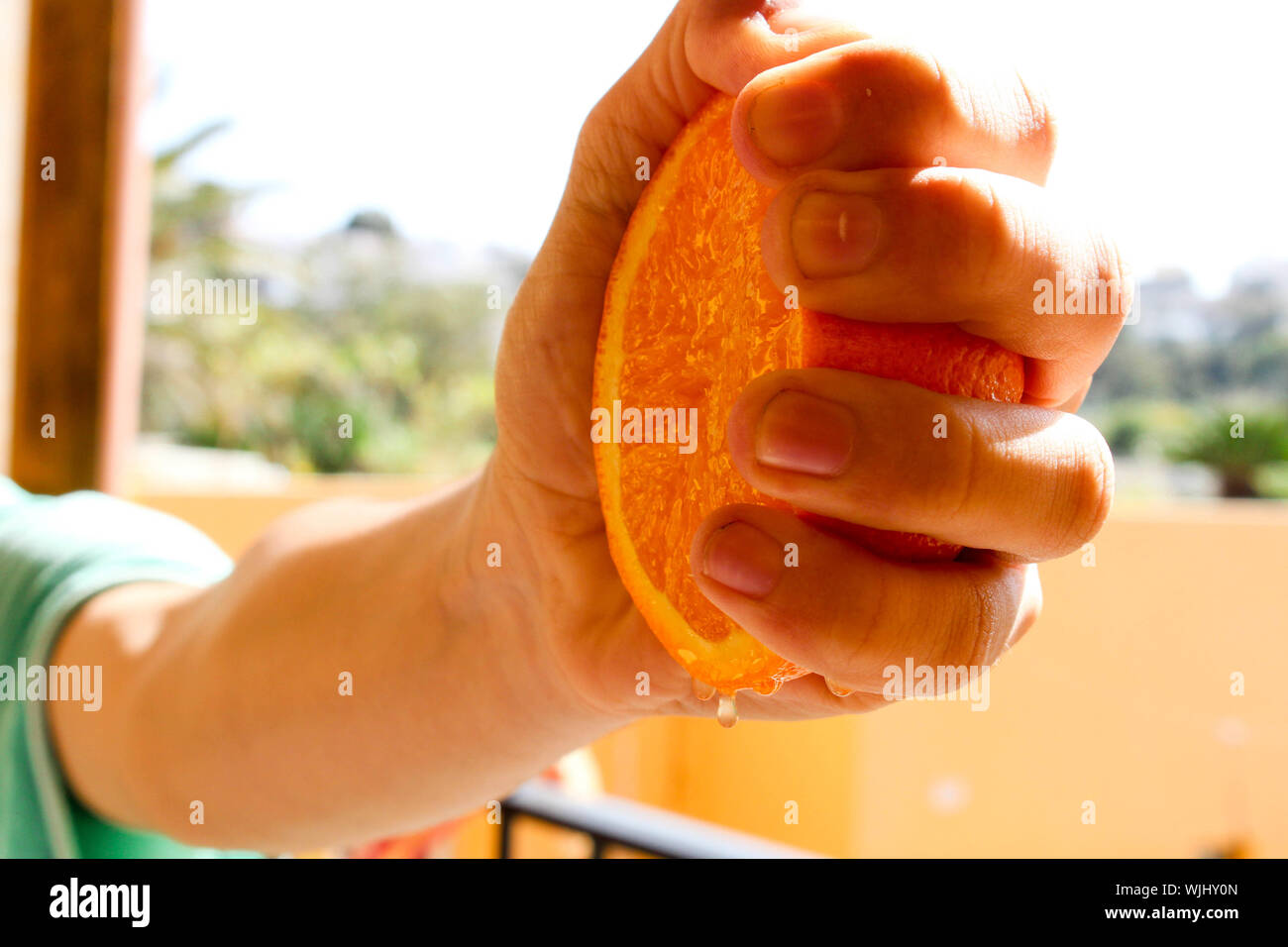 Hand squeezing orange hi-res stock photography and images - Alamy