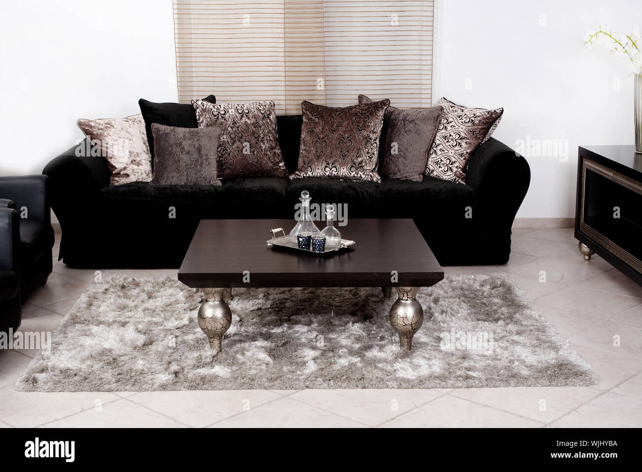Modern black coloured fabric couch, living room Stock Photo - Alamy