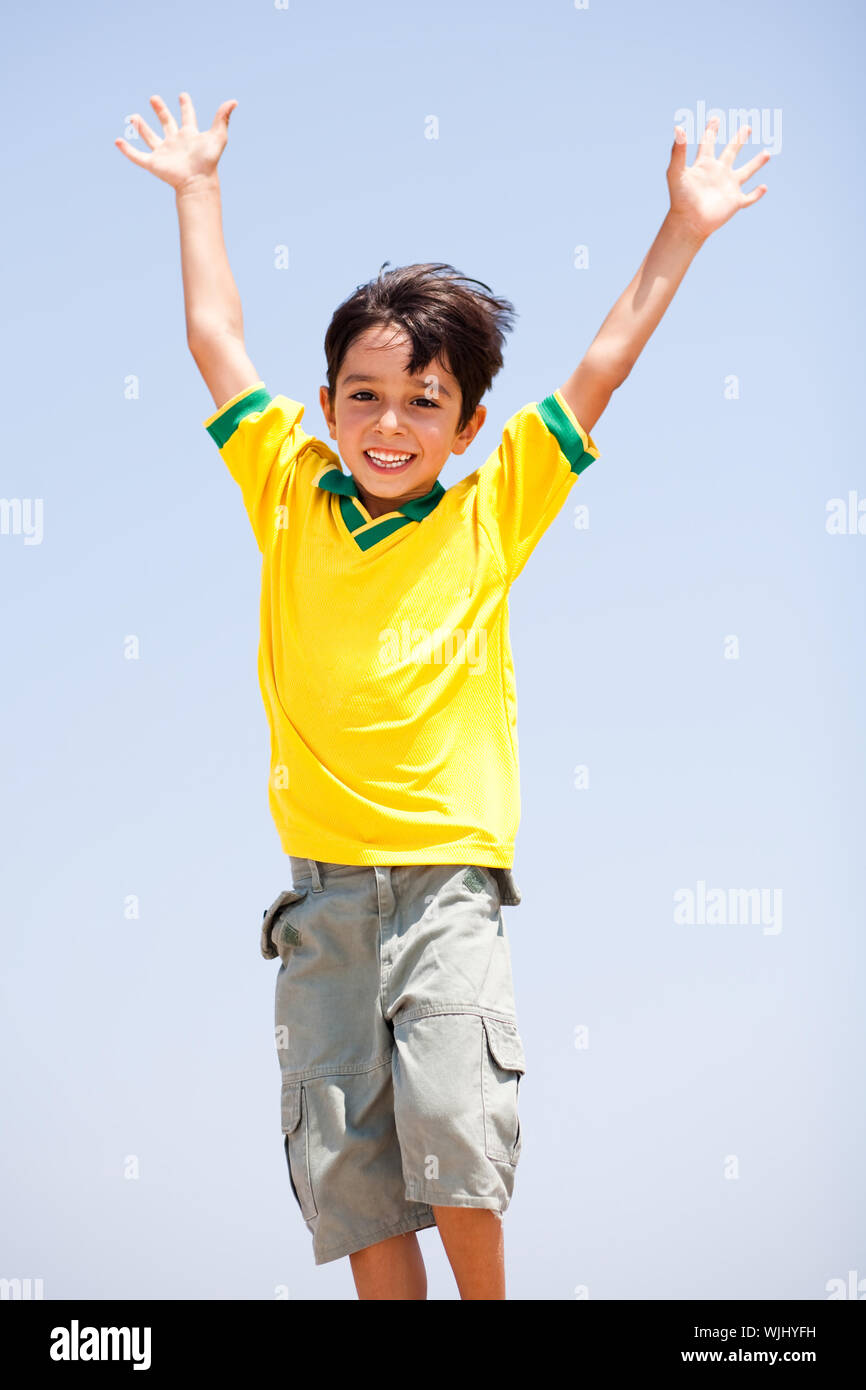 Young kid with raised arms posing in front of camera Stock Photo - Alamy