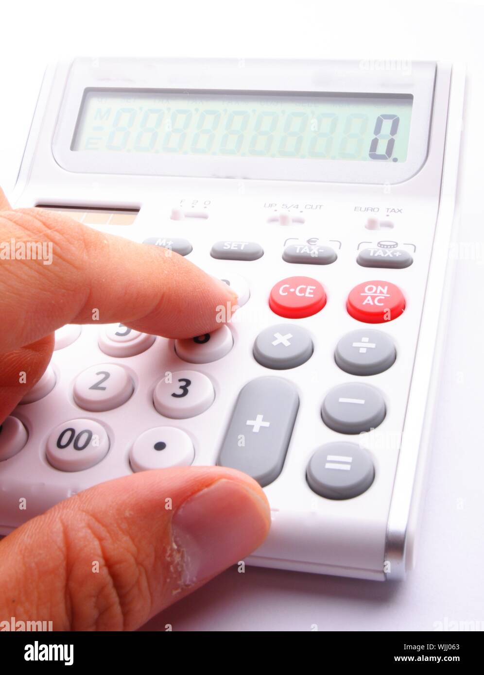 adding up figures concept with modern white calculator in office Stock ...