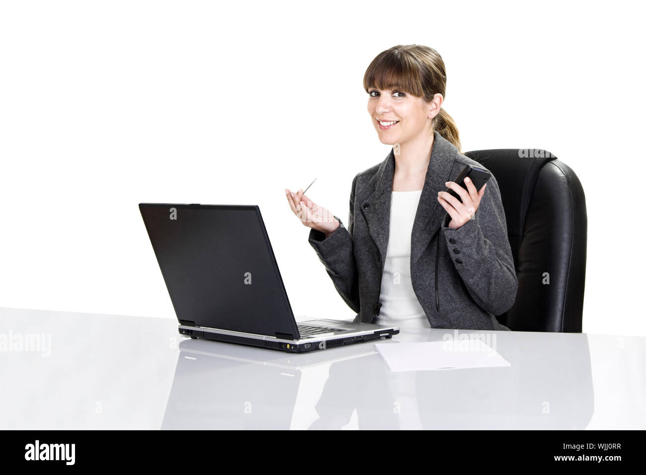 Beautiful business woman at office working - isolated on white ...