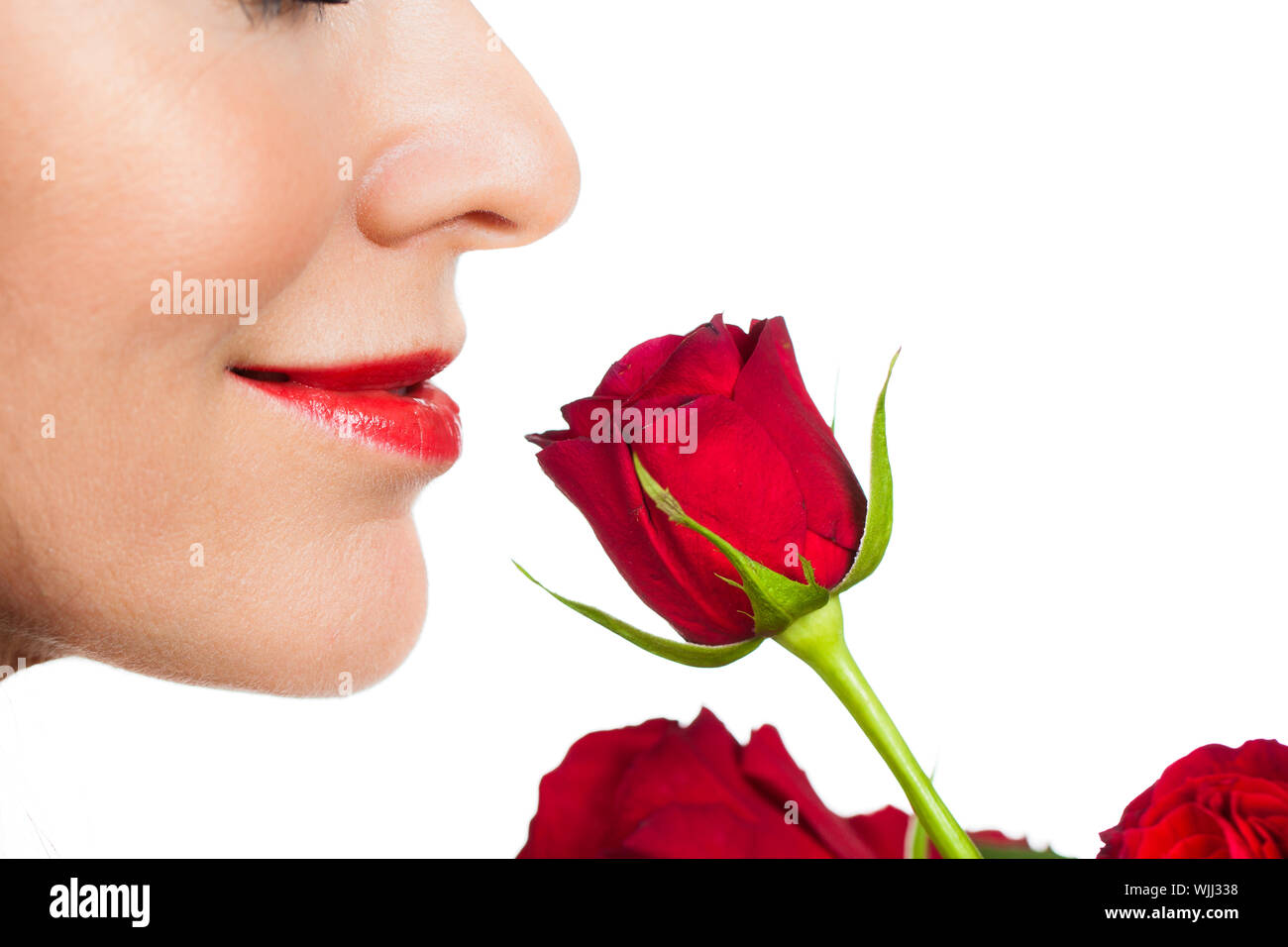 Woman with red hair smelling a red rose hi-res stock photography and ...