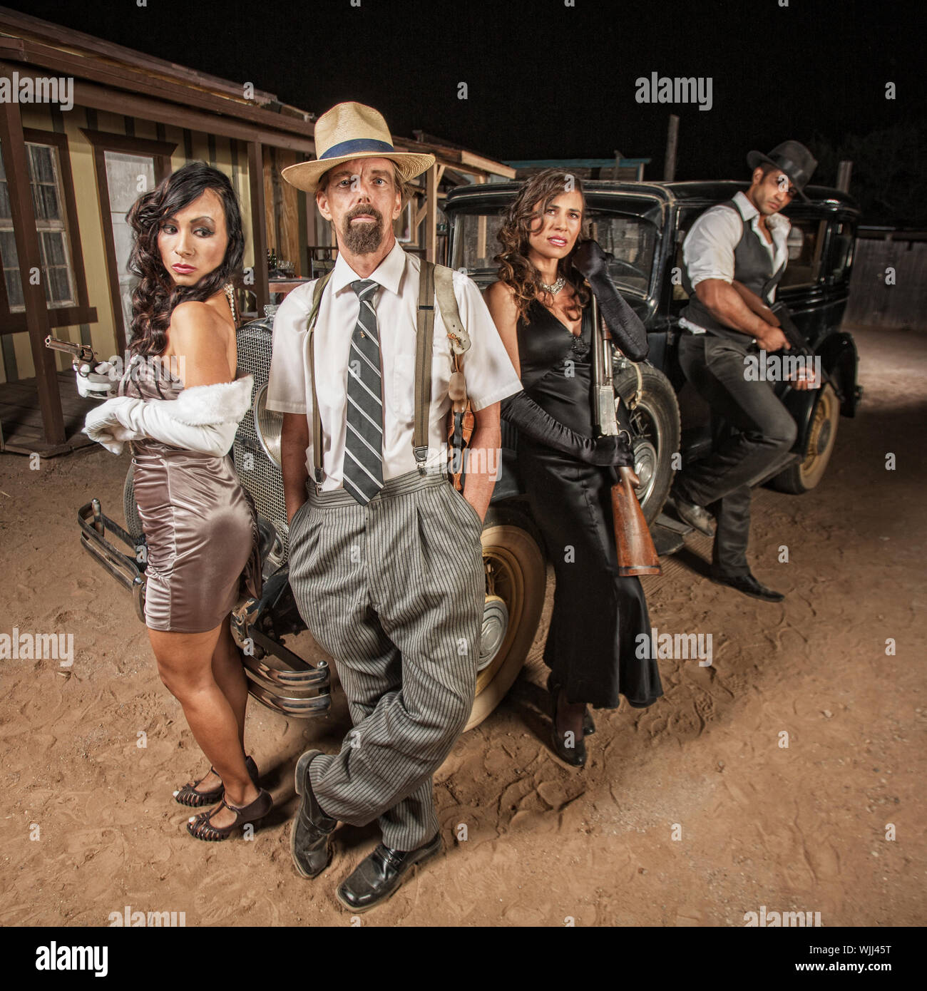 Gangster with hands in pockets next to partners in crime Stock Photo ...
