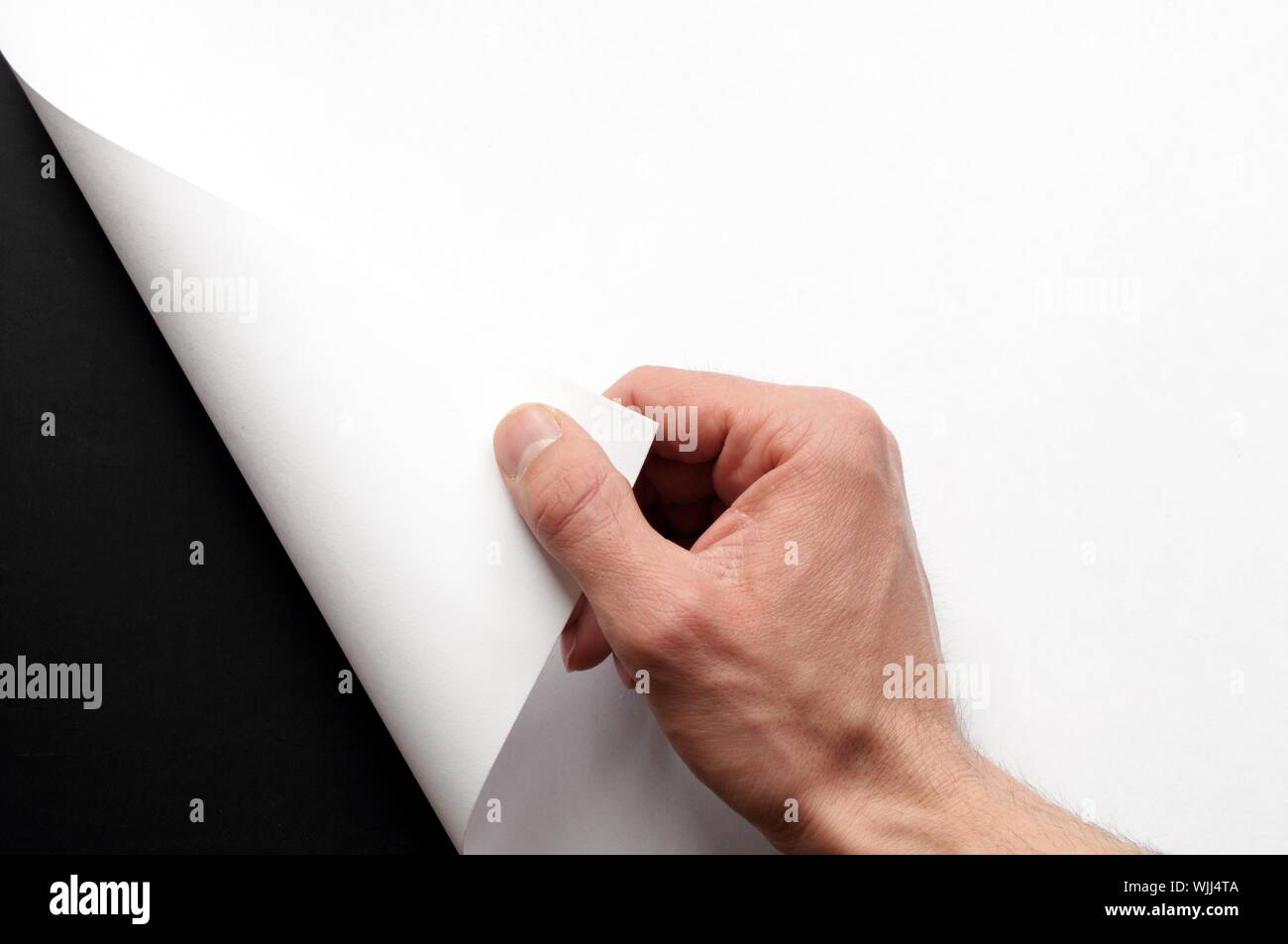 hand turning over blank sheet of paper Stock Photo - Alamy