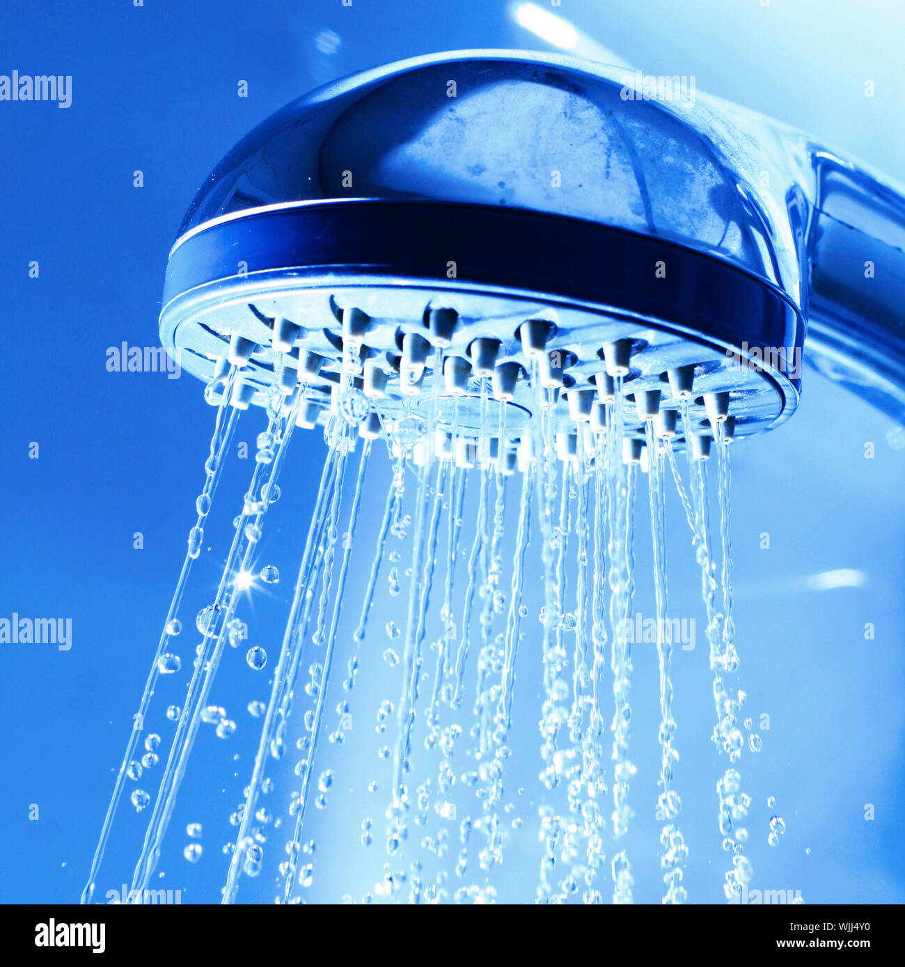 Water jet fresh shower in blue light Stock Photo - Alamy