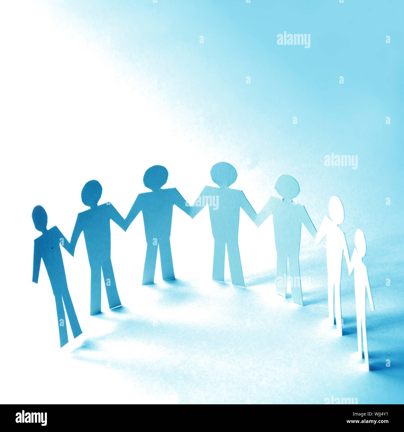 Paper people linked together unity concept Stock Photo - Alamy