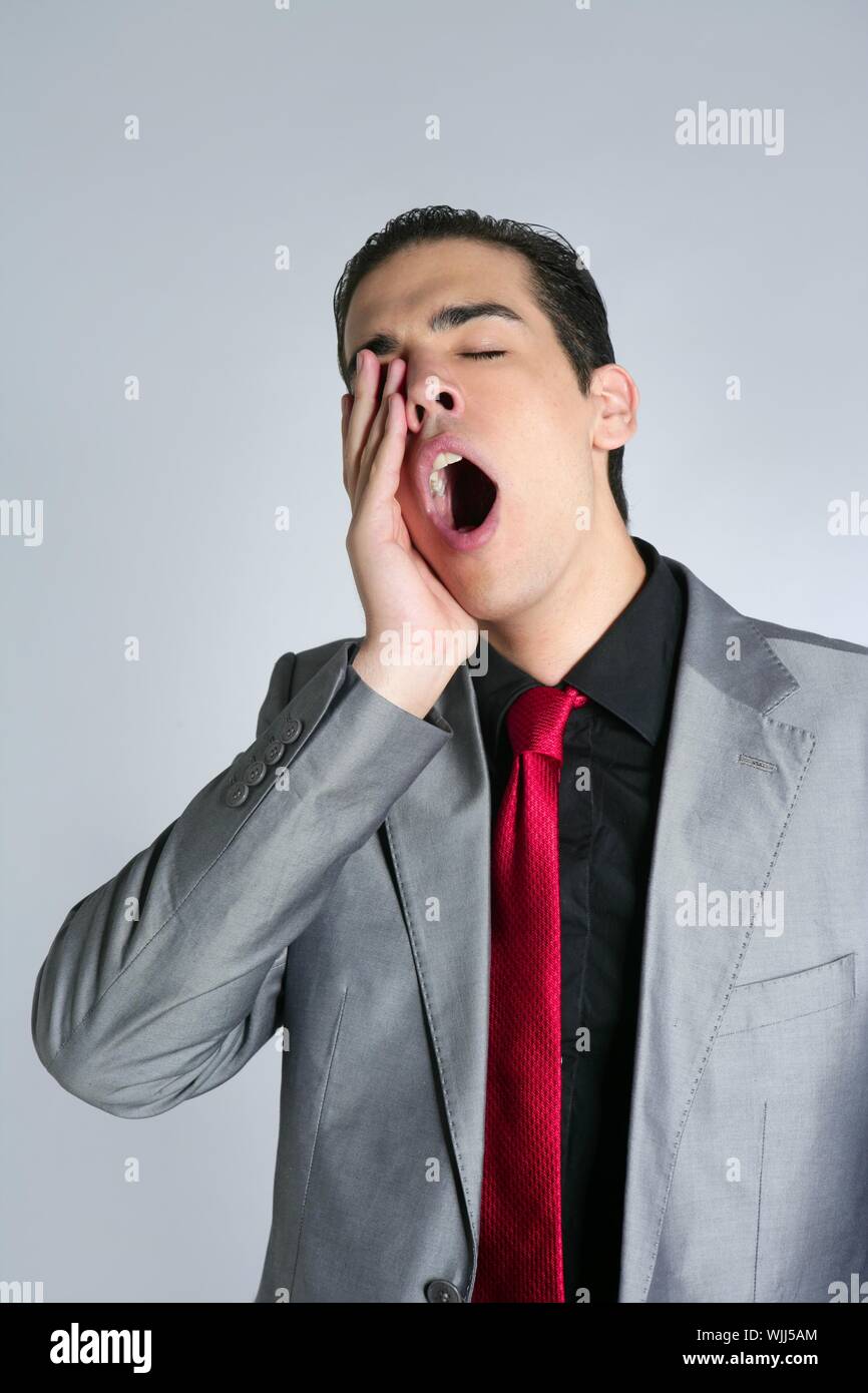 Businessman yawn boring on gray background with suit and red tie Stock ...