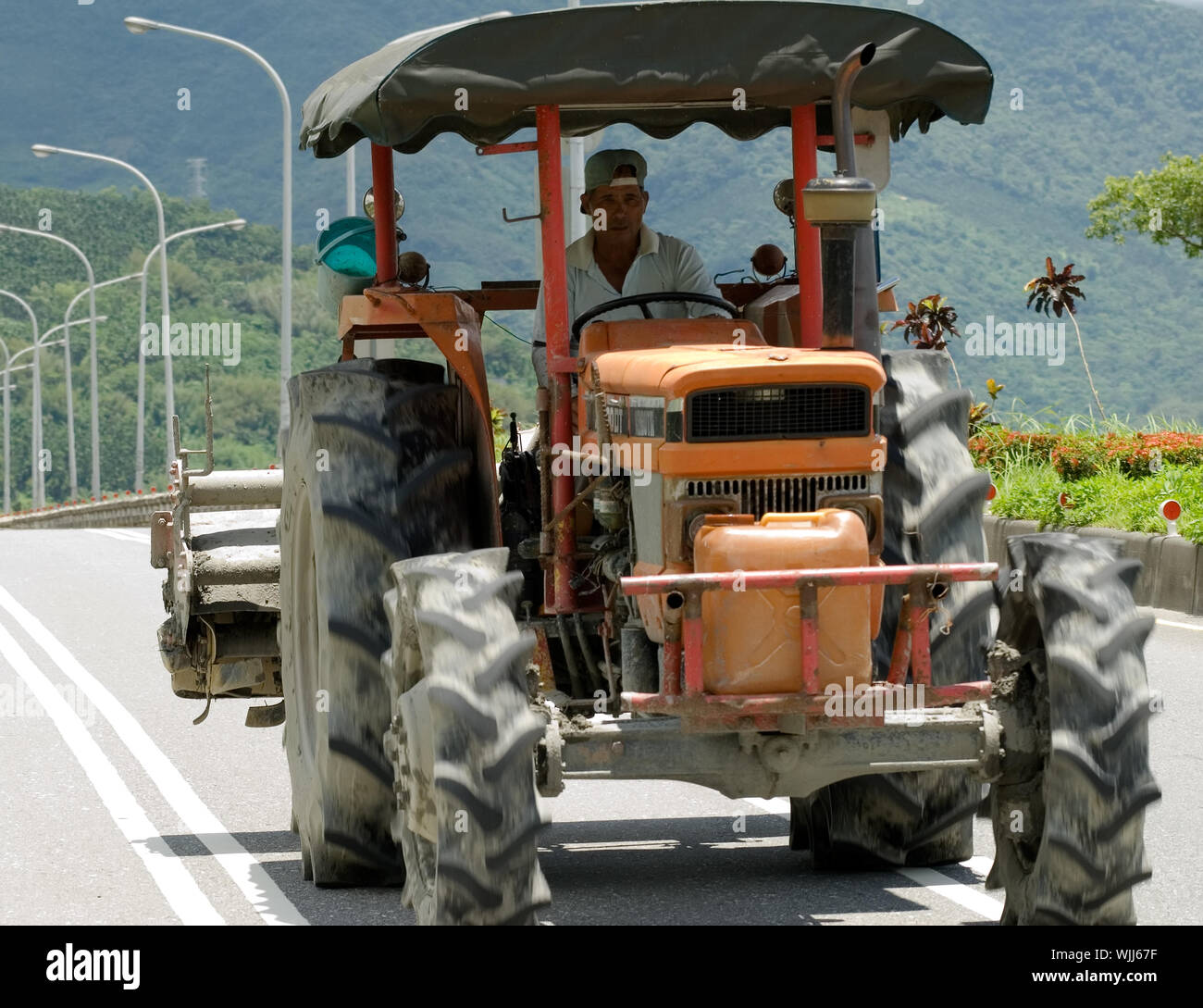 Here is a power tiller on the road Stock Photo - Alamy