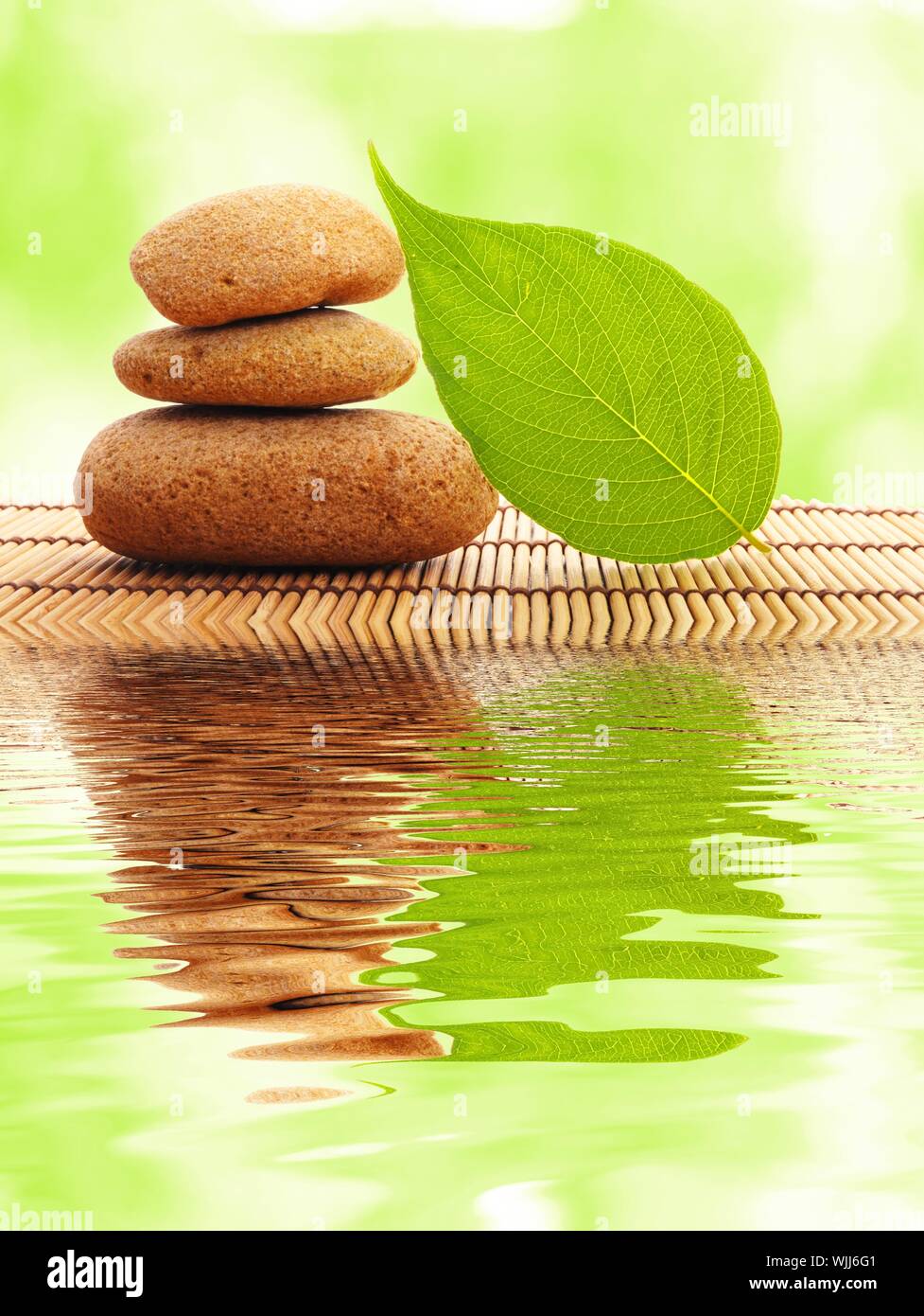 zen stones and water reflection showing spa concept Stock Photo - Alamy