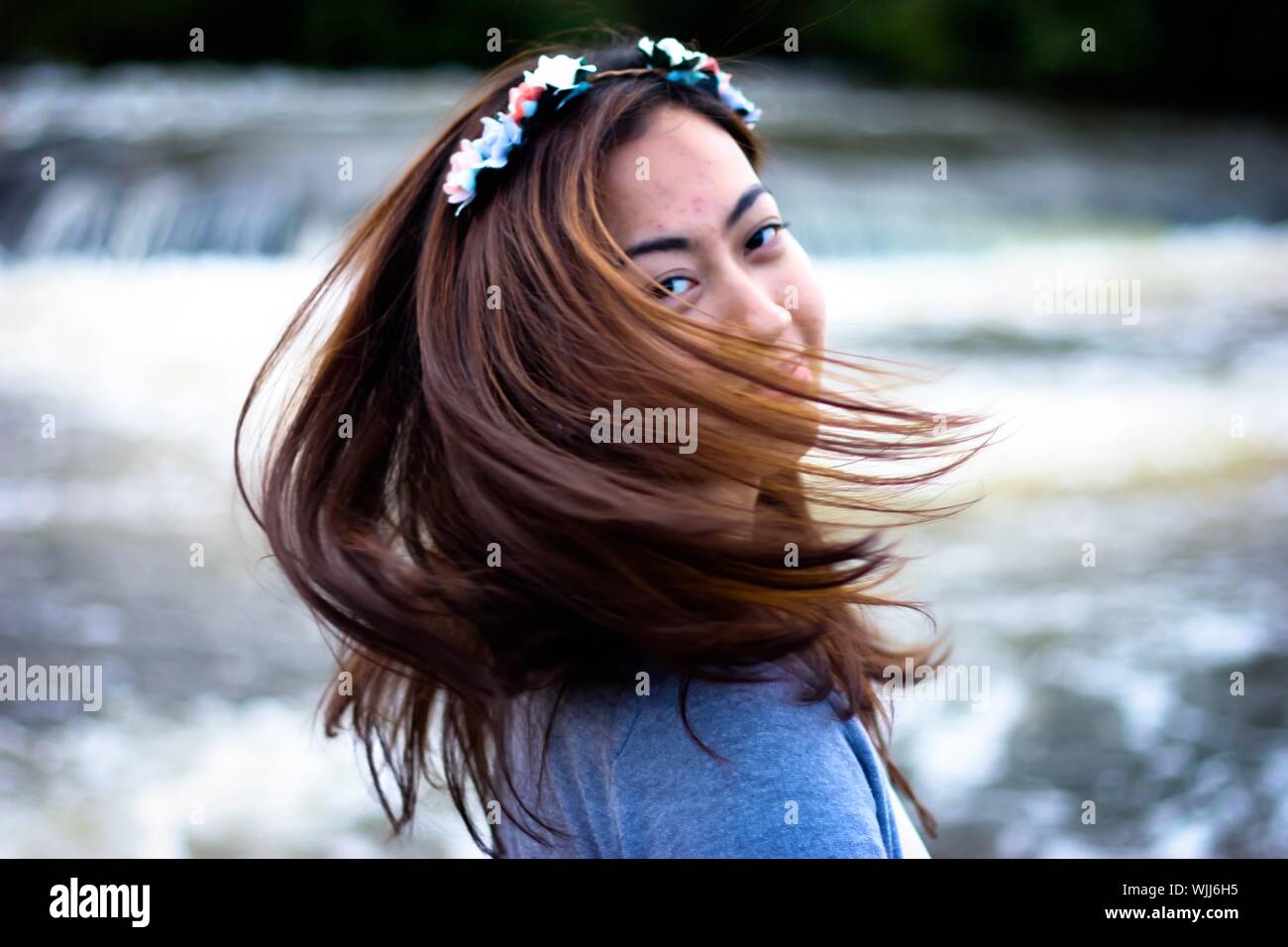 Turning back smiling hi-res stock photography and images - Alamy