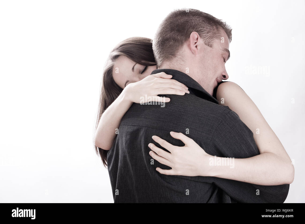 Studio shot of young loving couple caring Stock Photo - Alamy