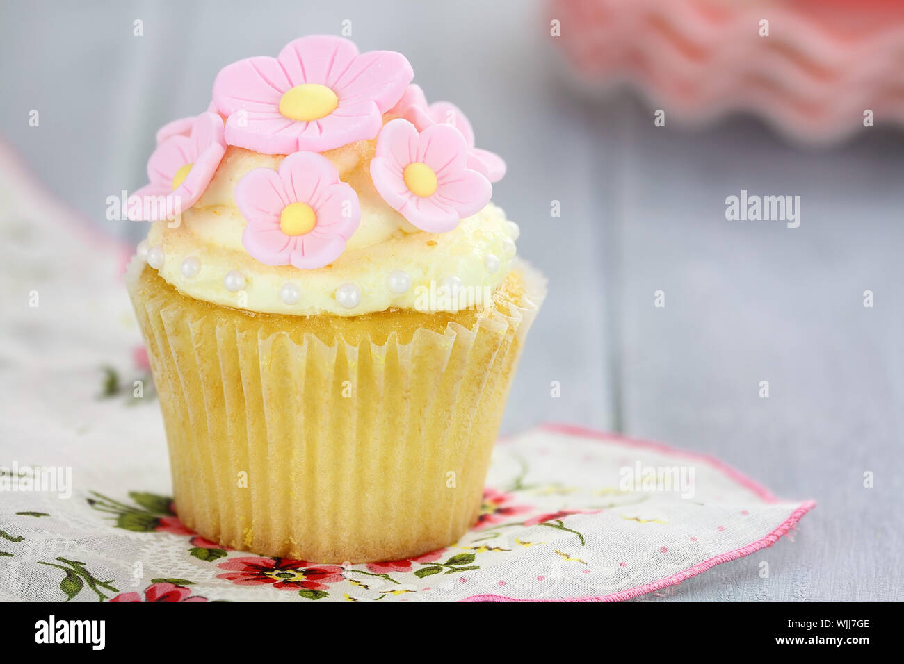 Pretty yellow and pink cupcakes with extreme shallow depth of field ...