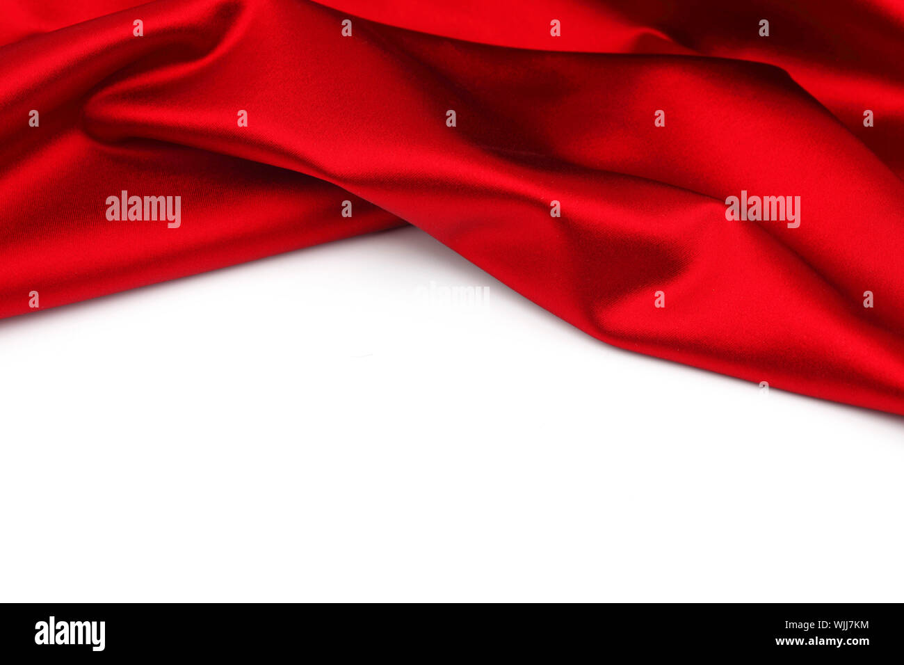 Folded red satin on white background Stock Photo - Alamy