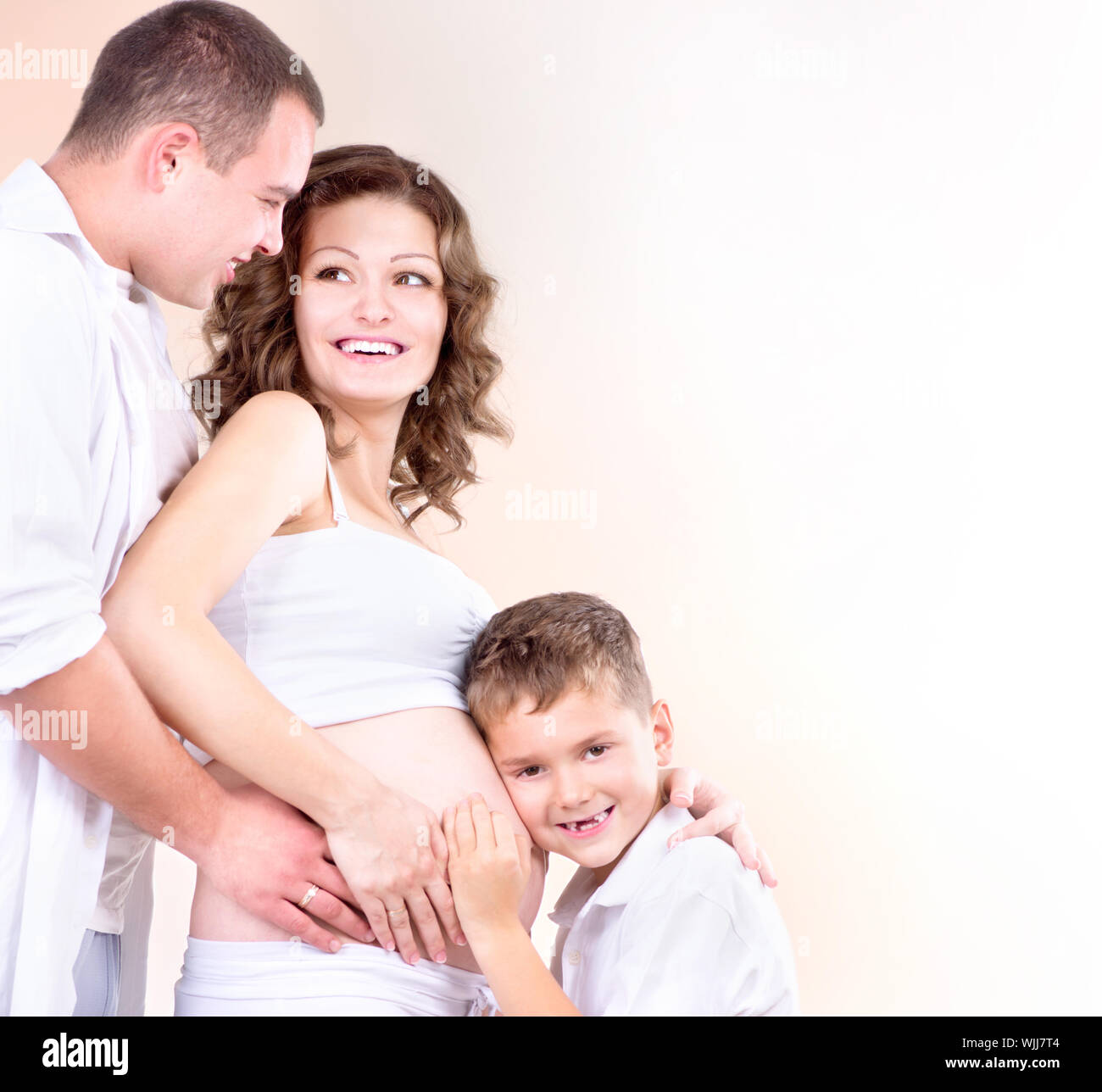 Happy Family Expecting Baby. Kid Listening Pregnant Belly Stock Photo ...