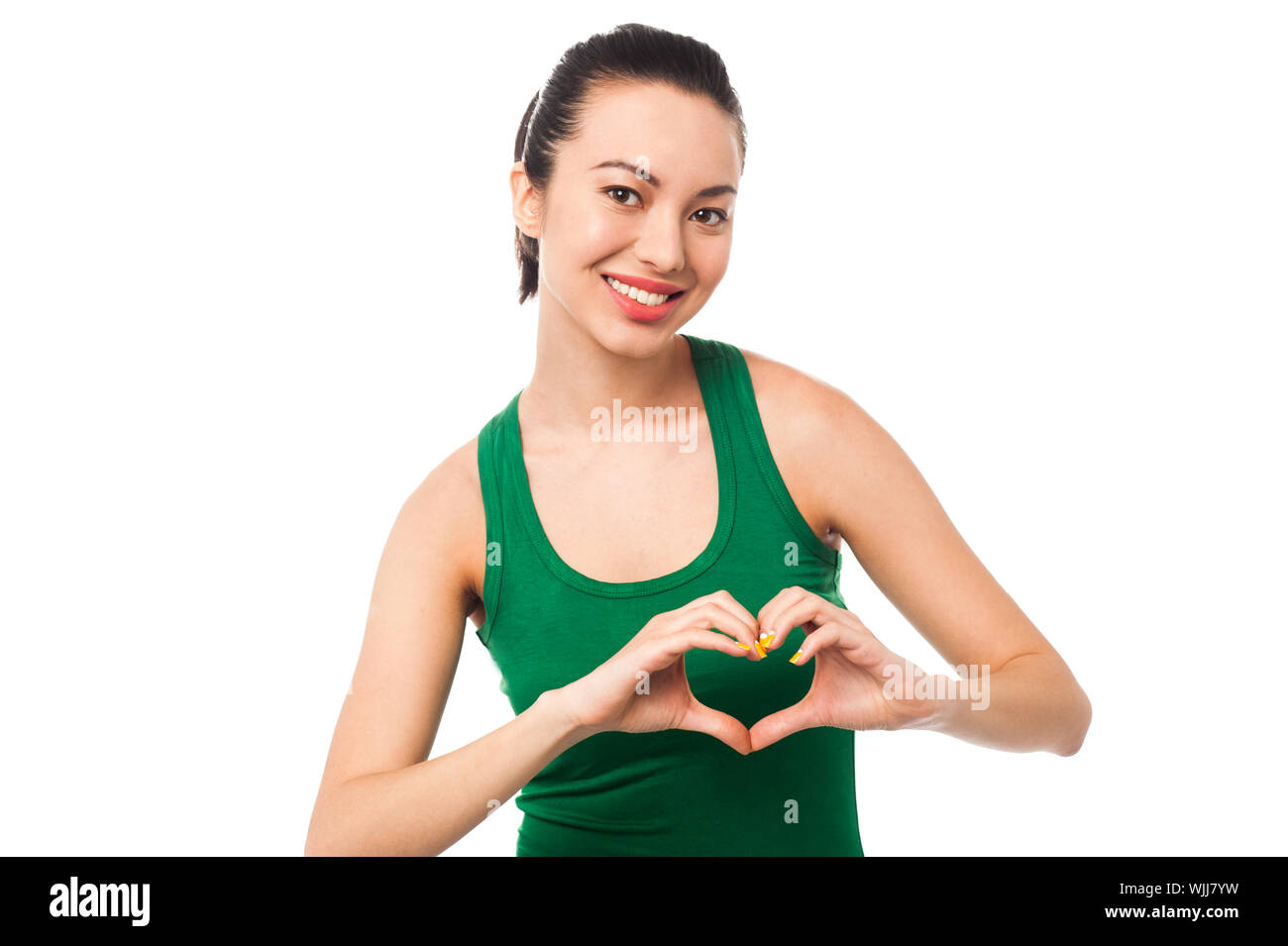 Pretty young girl making heart symbol with hands Stock Photo - Alamy