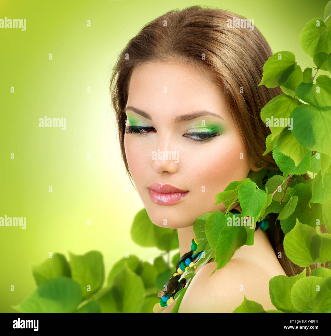 Beautiful Girl with Green Leaves. Spring Beauty outdoor Stock Photo - Alamy