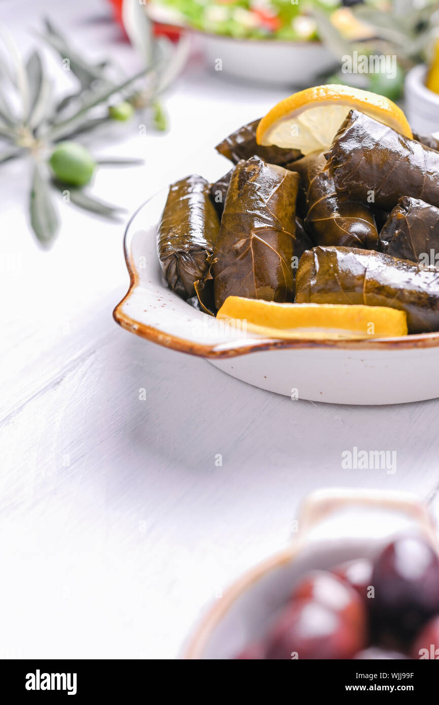 Traditional greek cuisine. Wrapped rice in grape leaves. Dolma with ...
