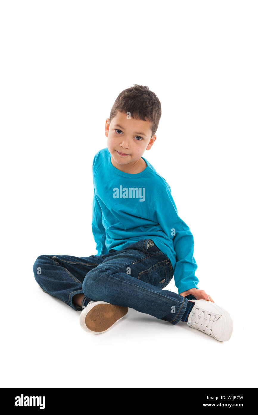 Little boy is sitting in the studio isolated over white background ...
