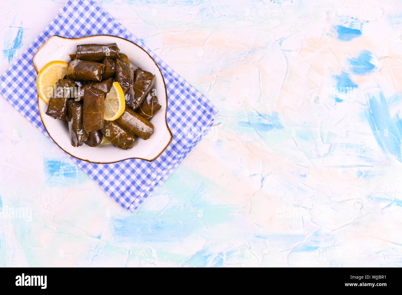 Traditional greek cuisine. Wrapped rice in grape leaves. Dolma with ...