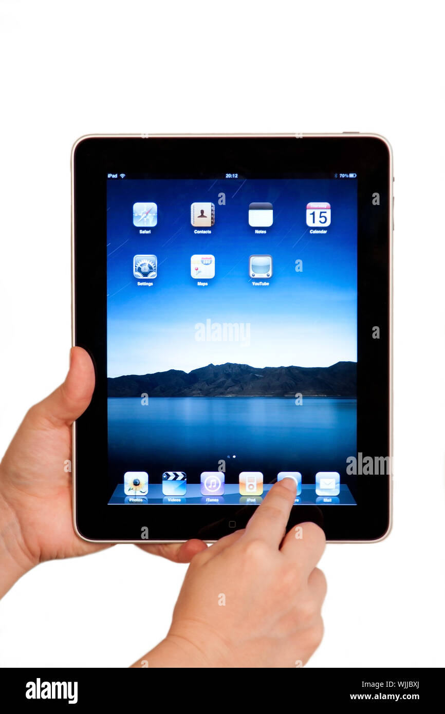 Female hands using Apple's iPad wireless handheld computer with apps ...