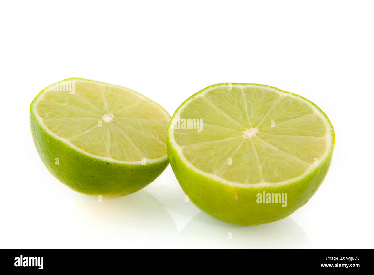 Yellow and green lemon cut into two pieces Stock Photo - Alamy