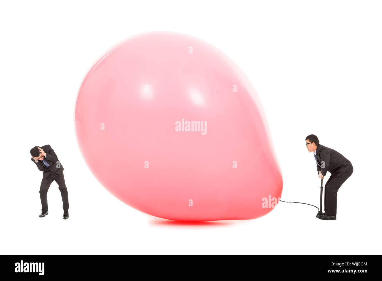 Businessmen scared balloon is inflated to burst Stock Photo - Alamy