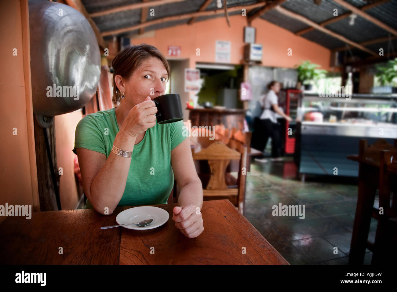Pretty adult woman in a Costa Rican cafe Stock Photo - Alamy