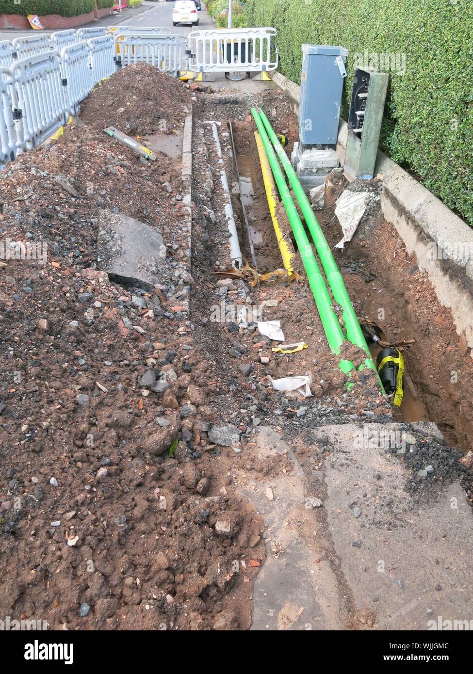 Photo of a residential street being dug up by a utility company for the ...