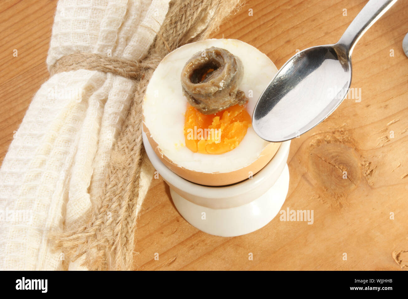 boiled egg with anchovy and a spoon Stock Photo - Alamy