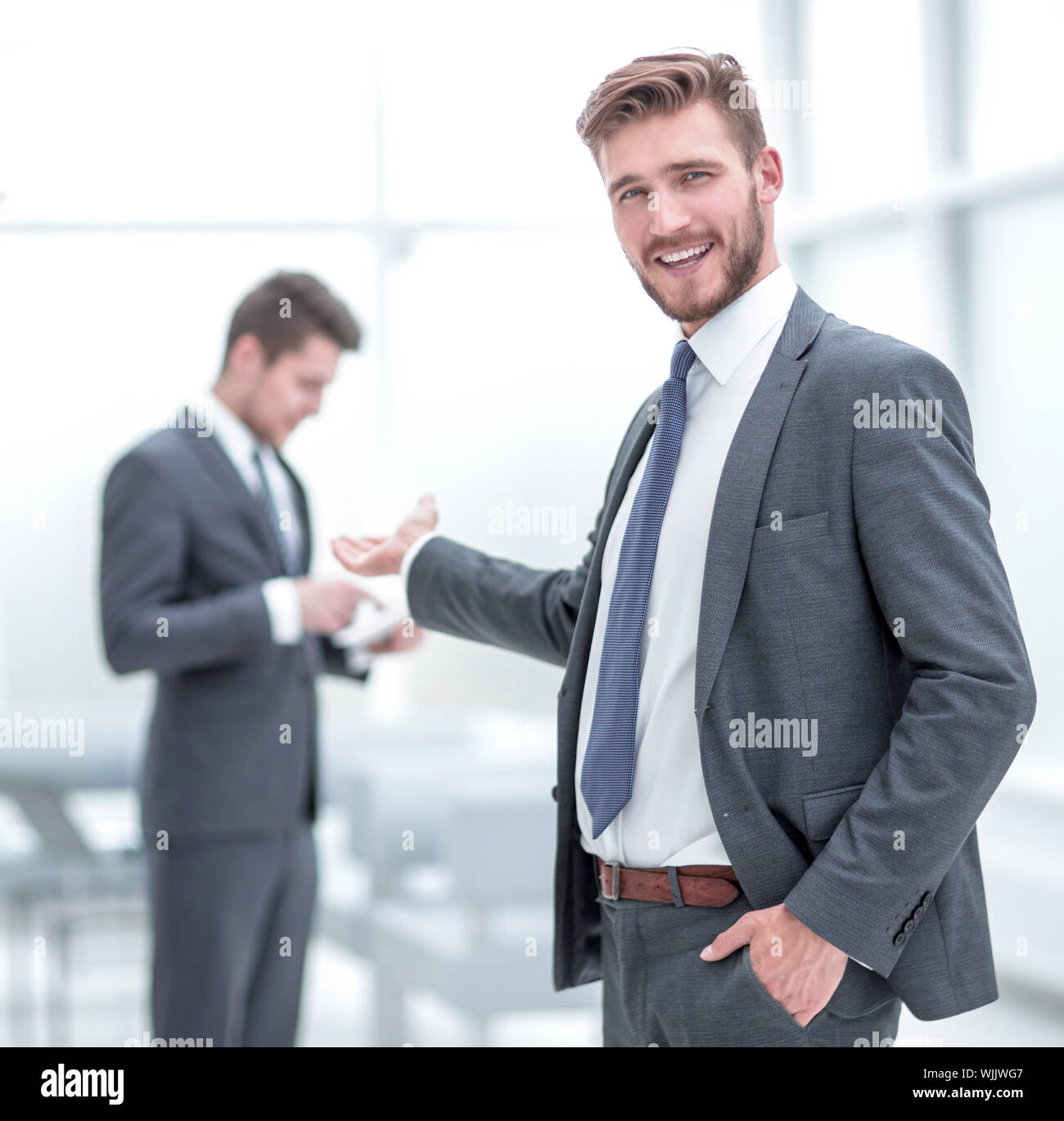 successful businessman invites you to the office Stock Photo - Alamy