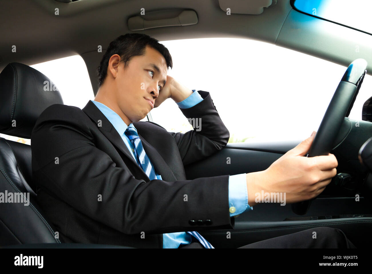 depressed businessman holding head and driving car Stock Photo - Alamy
