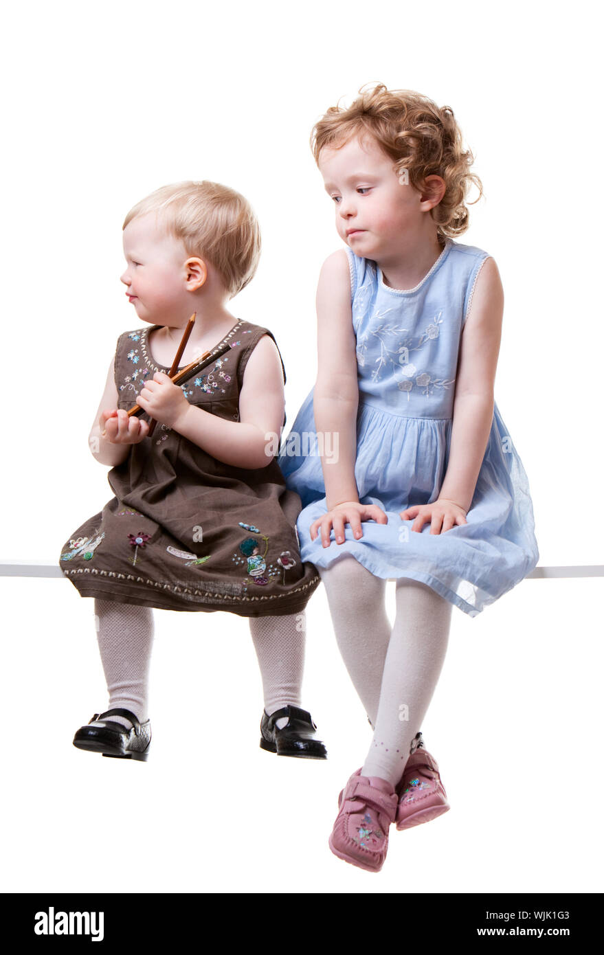 Studio photo of two sisters isolated on white Stock Photo - Alamy