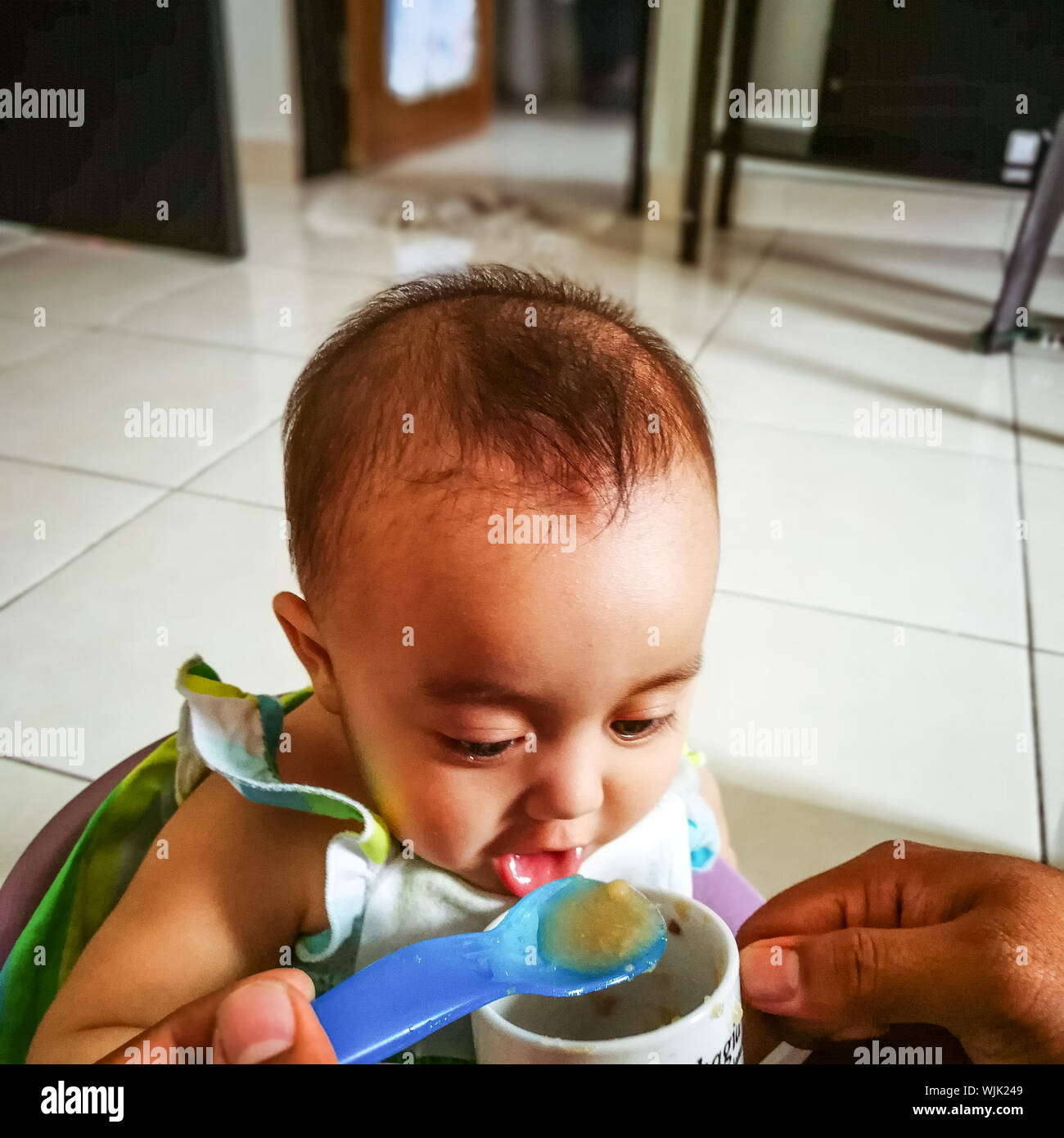 Baby girl eating food hi-res stock photography and images - Alamy