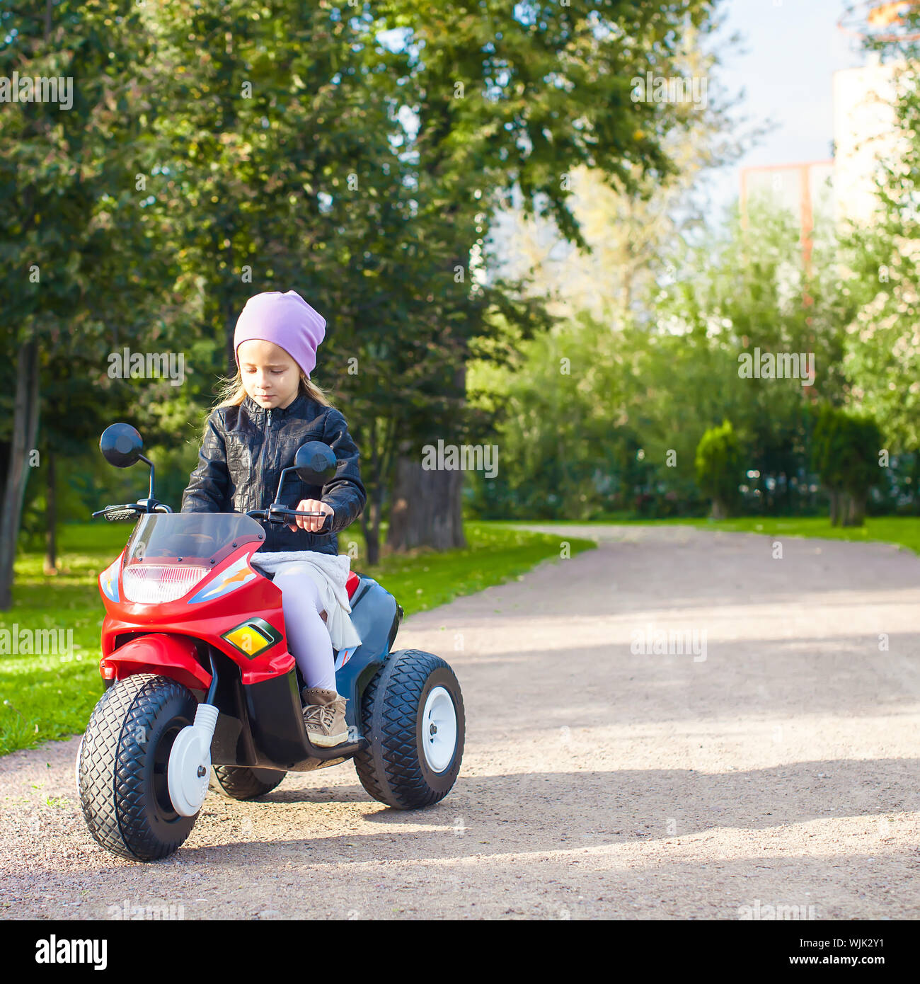 Adorable little girl riding a children's bike Stock Photo - Alamy