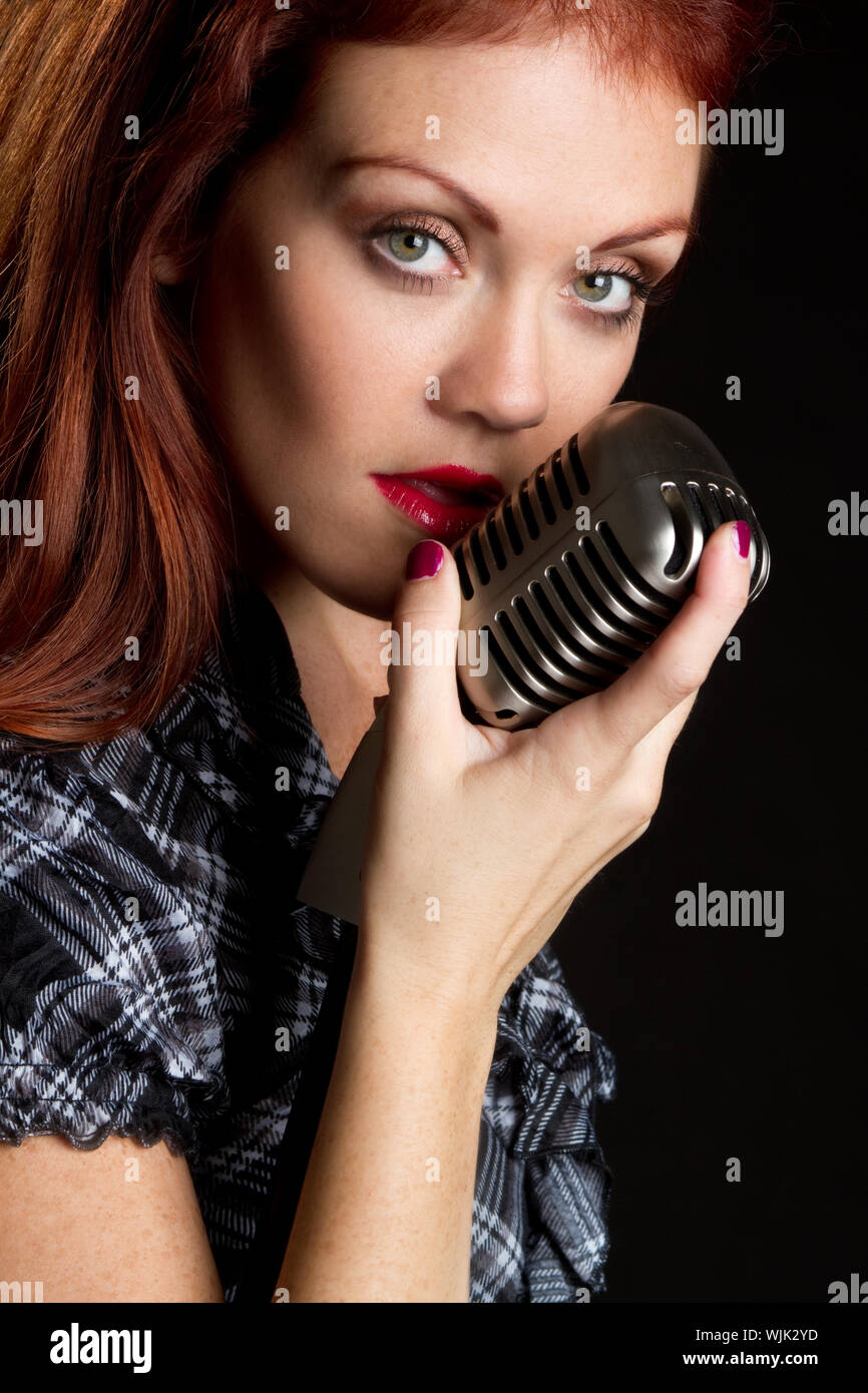 Woman singer with vintage microphone Stock Photo - Alamy