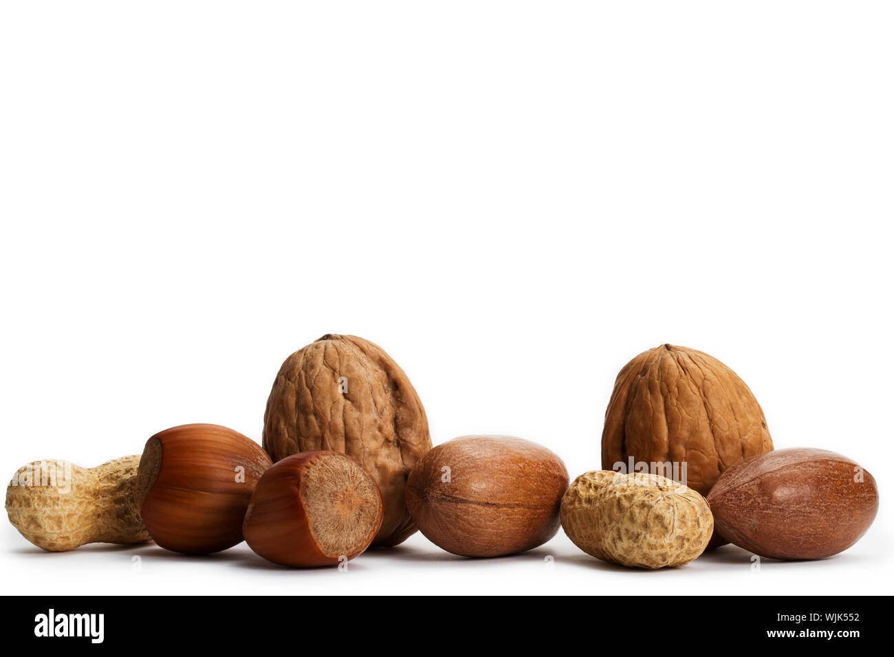 two of each pecan hazelnuts walnuts and peanuts on white background ...