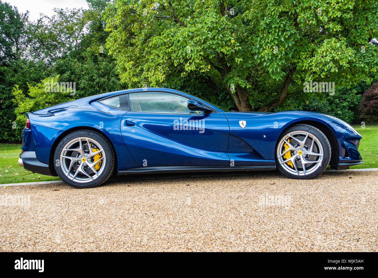 Side view of a 2019 blue Ferrari 812 superfast s-a on a country estate ...