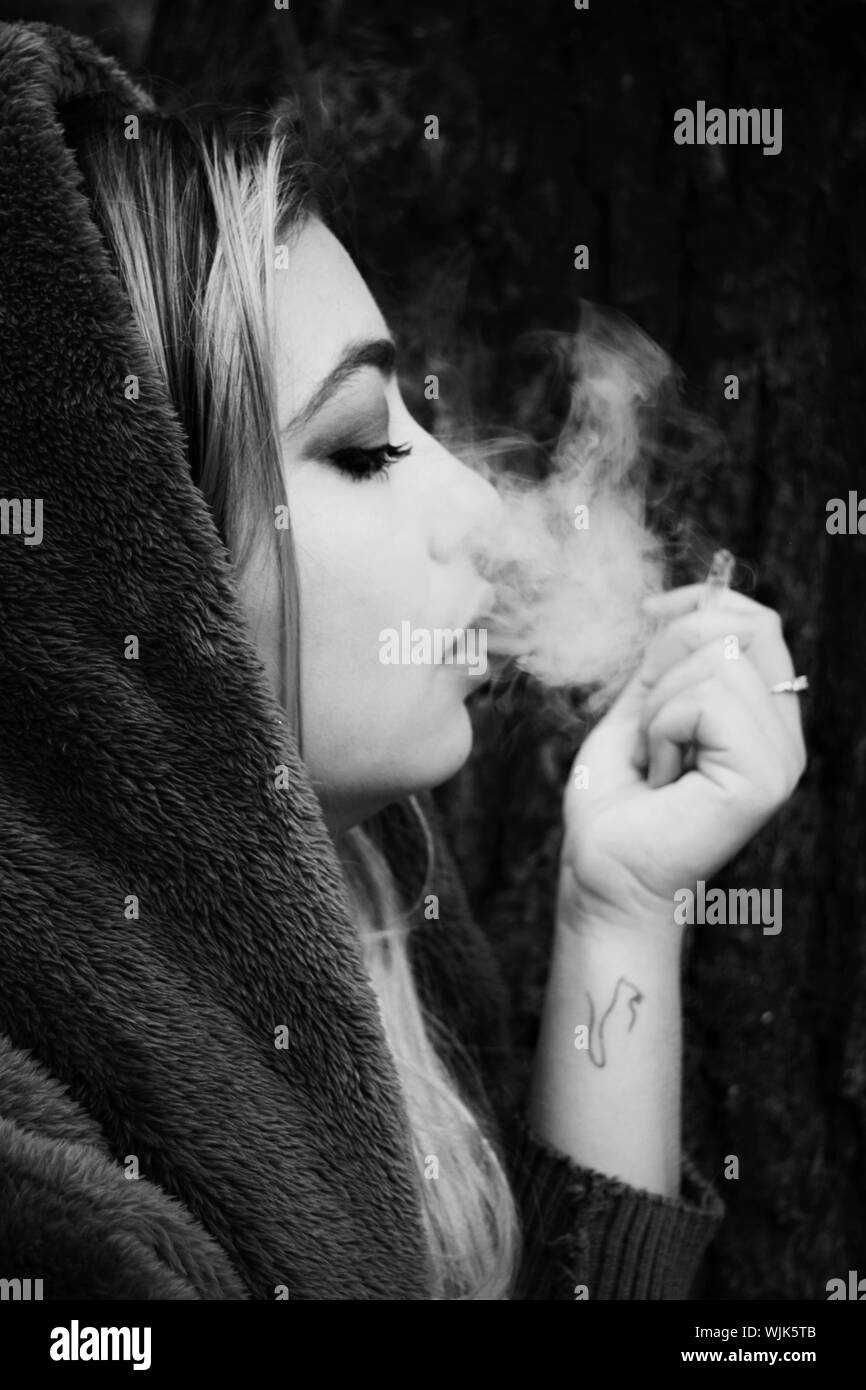 Woman exhaling smoke hi-res stock photography and images - Alamy
