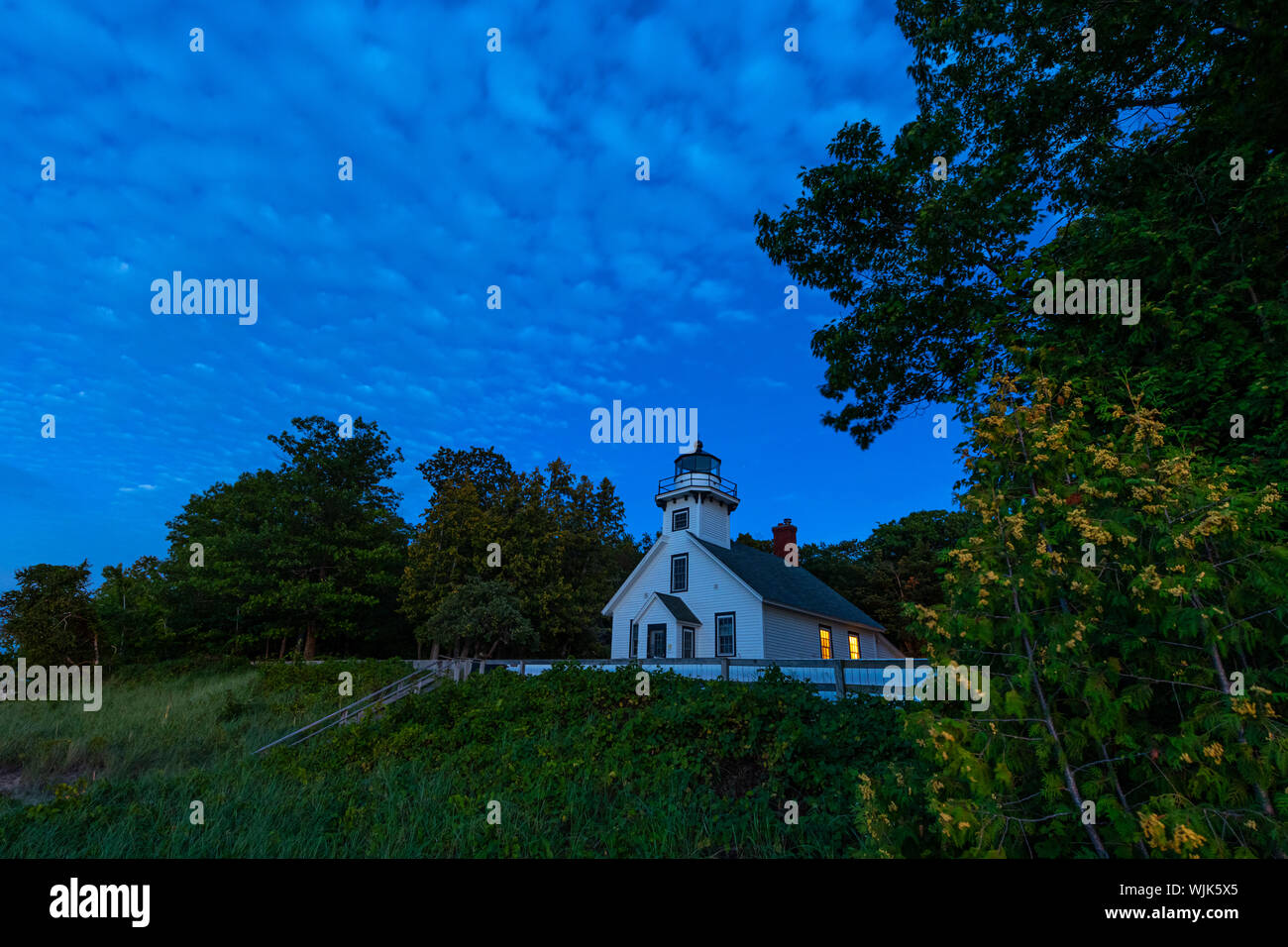 Old Mission Point Lighthouse at twilight showing lights in windows, at ...
