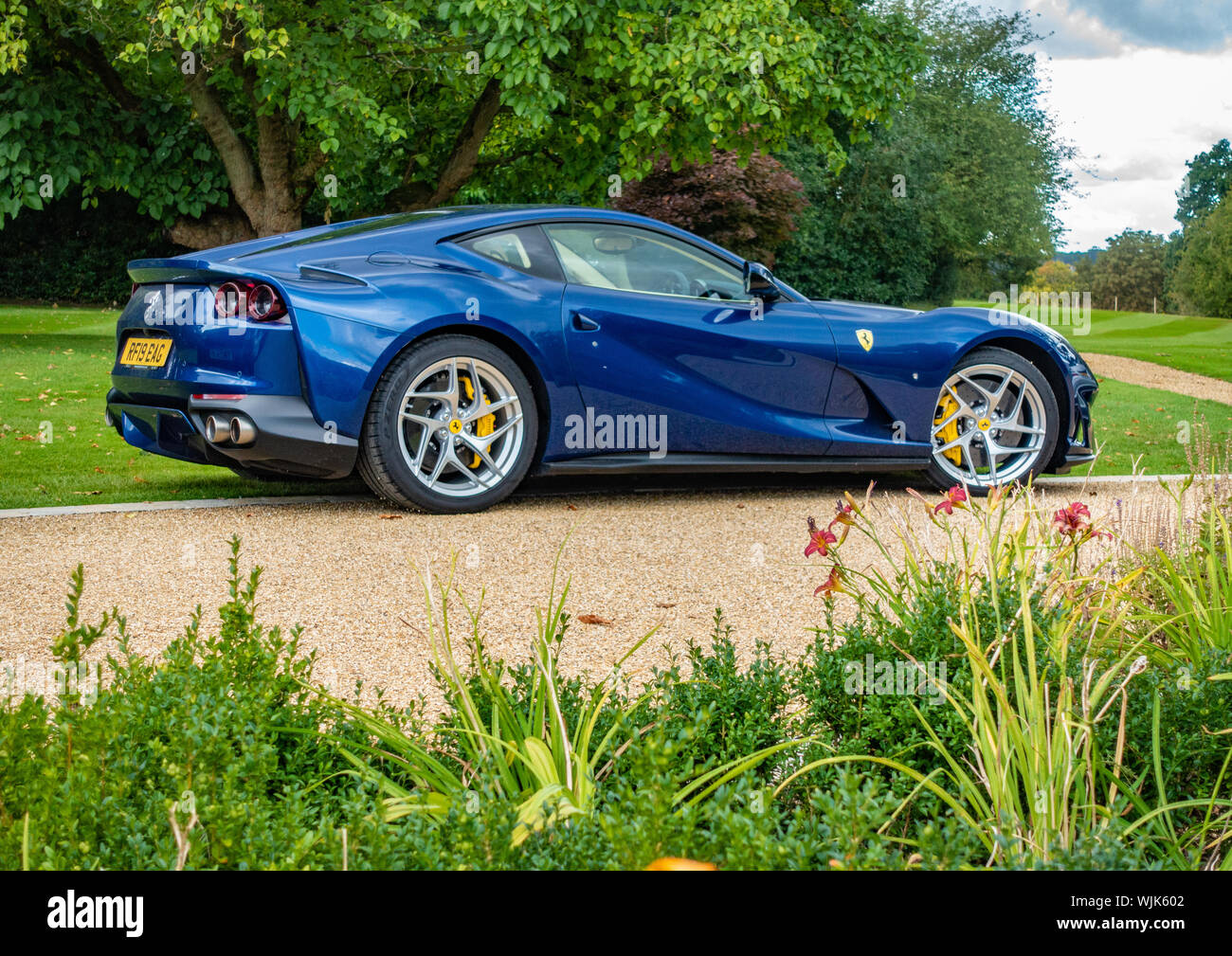 Side view of a 2019 blue Ferrari 812 superfast s-a on a country estate ...
