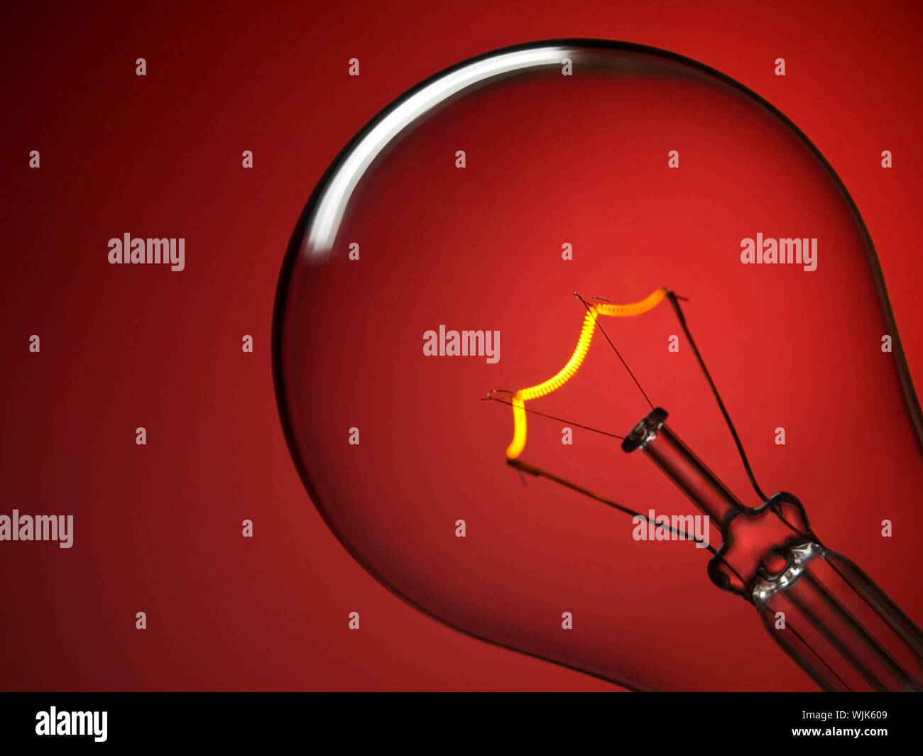 Close up on a transparent light bulb over a red background Stock Photo ...