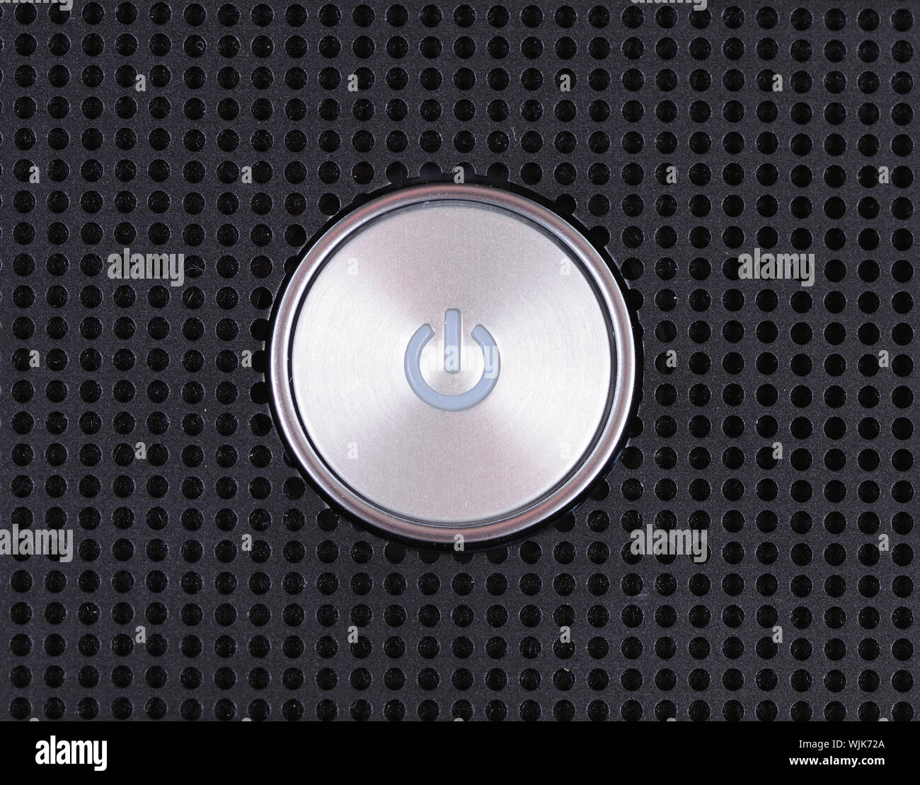Power button on metal hole background Stock Photo - Alamy