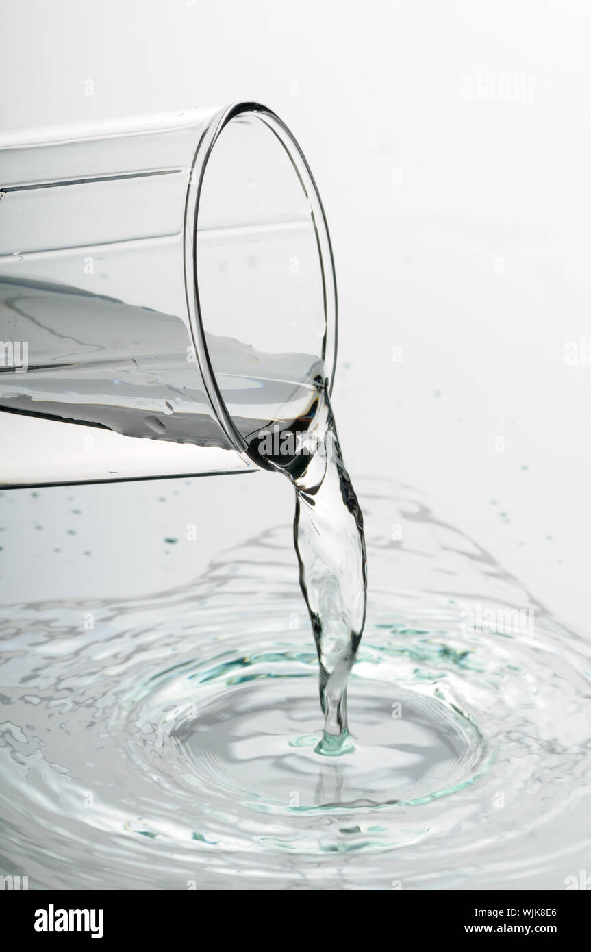 Pure transparent water pour from a glass Stock Photo - Alamy